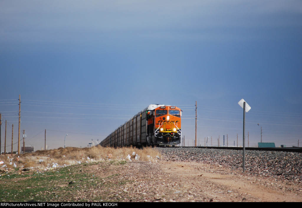 BNSF 6835 with BNSF 6870 behind her climb the Kingman Grade pulling a Vehicle Train towards ...